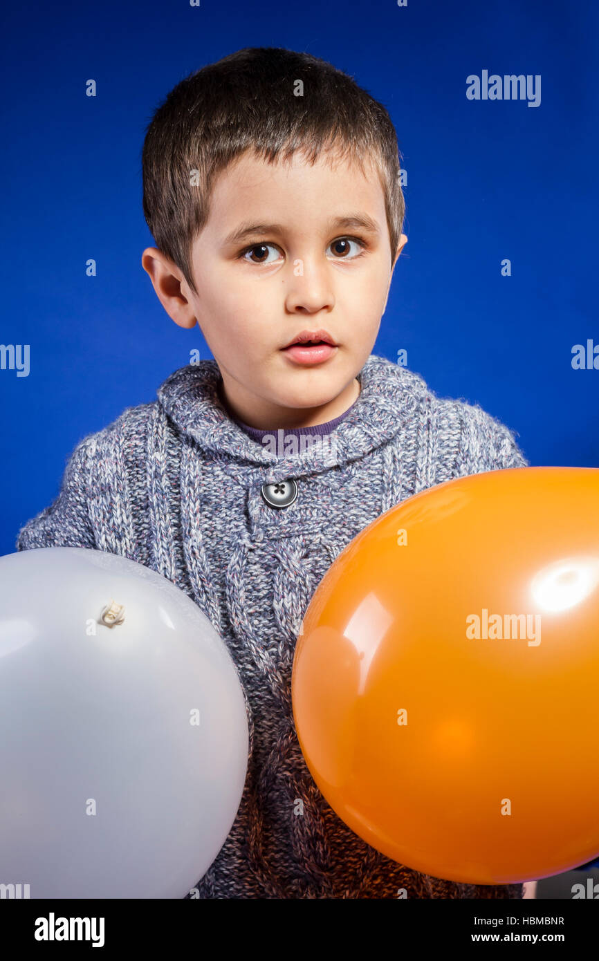 Celebration child playing with colored balloons at a birthday party ...