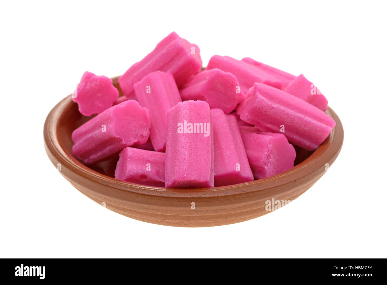 A small bowl filled with pink bubble gum isolated on a white background ...