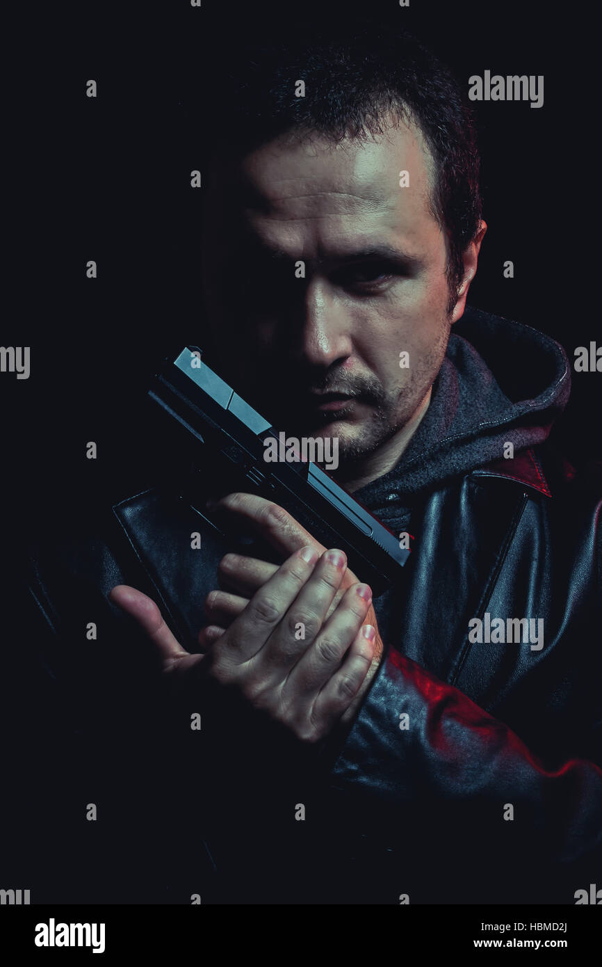 ganster, dangerous man with a gun, shooting Stock Photo - Alamy