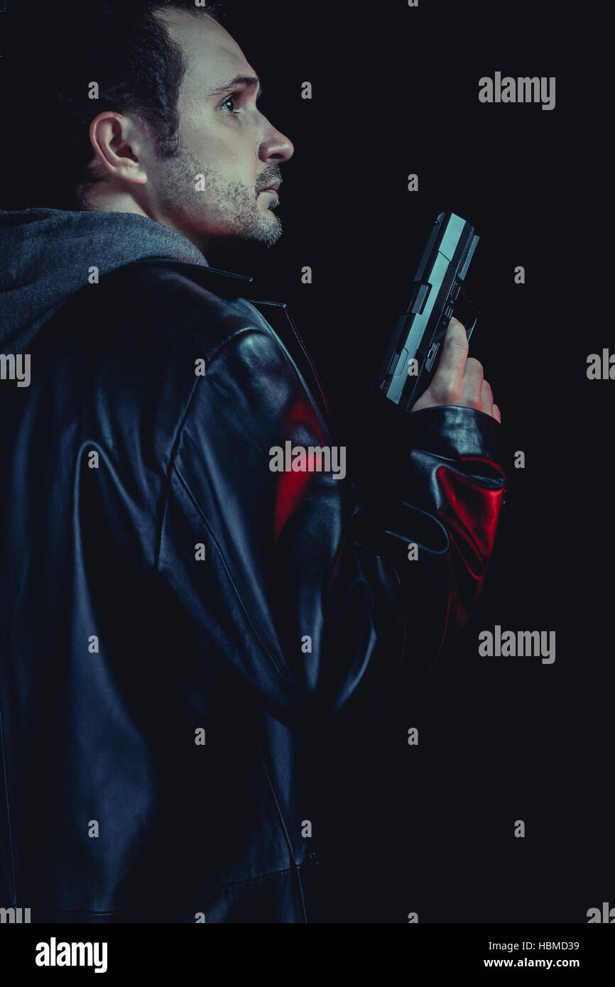 Lone man armed with a pistol, robber Stock Photo - Alamy