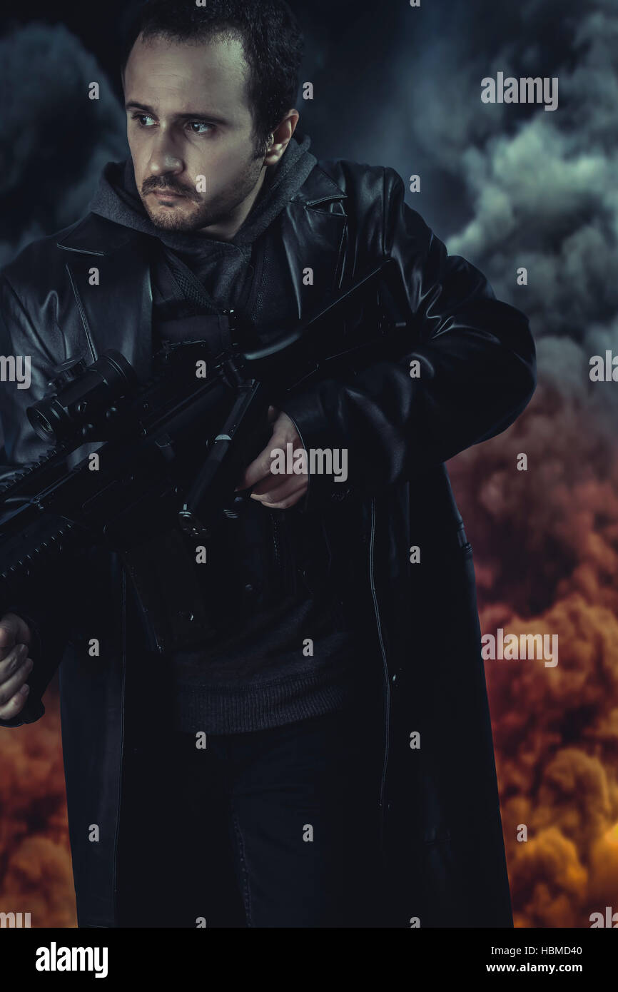 Armed man on background with explosion of fire and smoke Stock Photo ...