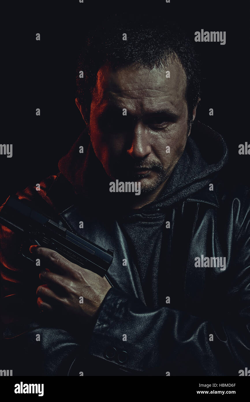 Gangster, man with a gun ready to shoot Stock Photo - Alamy