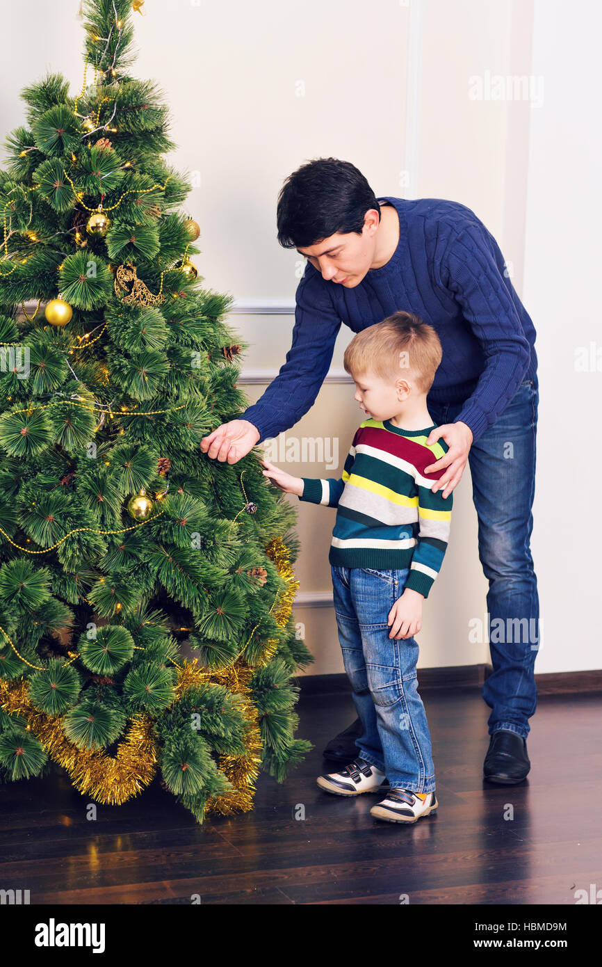 Father and son are decorating the Christmas tree Stock Photo - Alamy