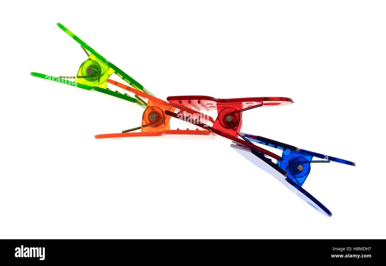 Several colorful plastic clips clipped together isolated on a white ...
