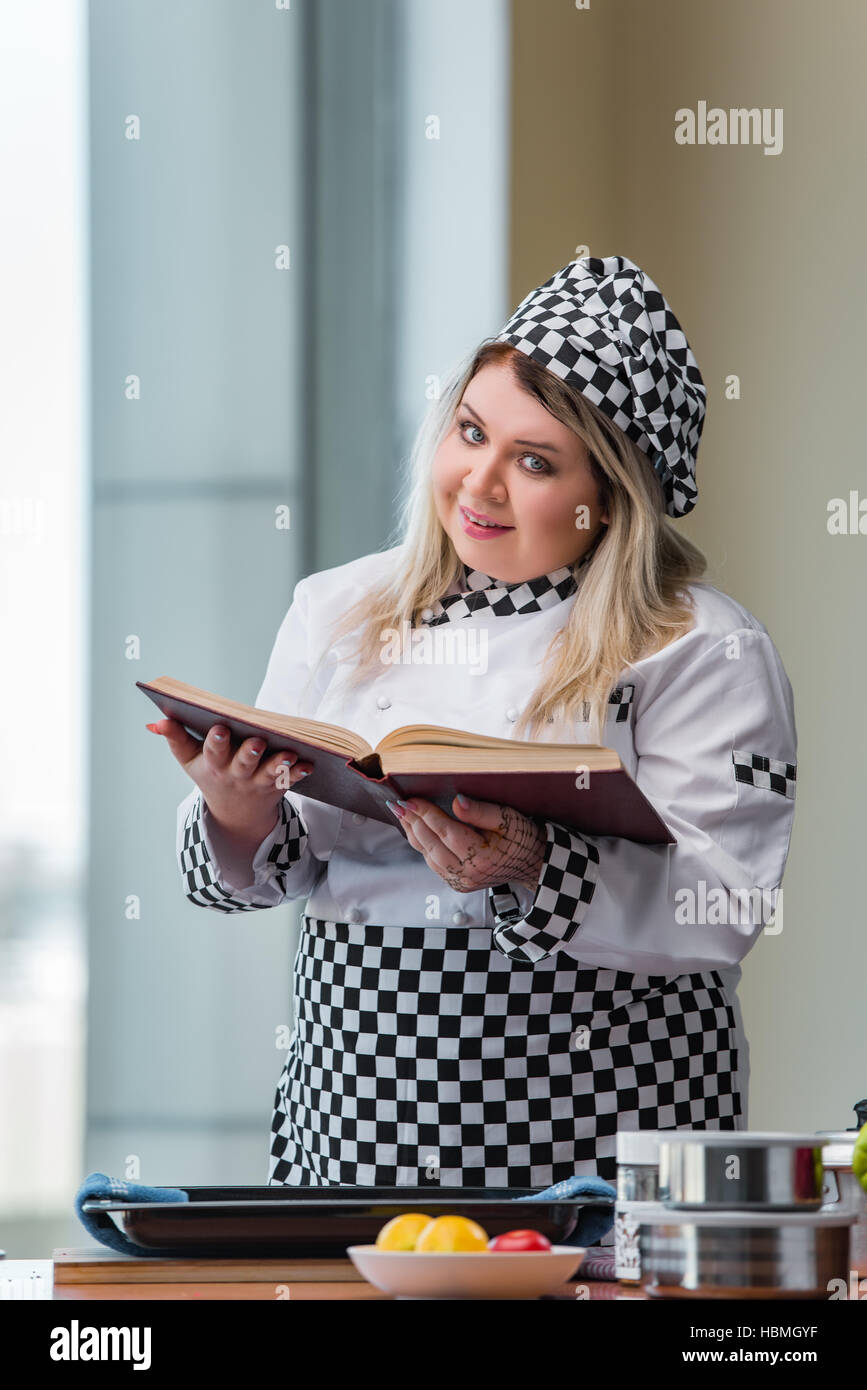 Young chef cook working in the kitchen Stock Photo - Alamy