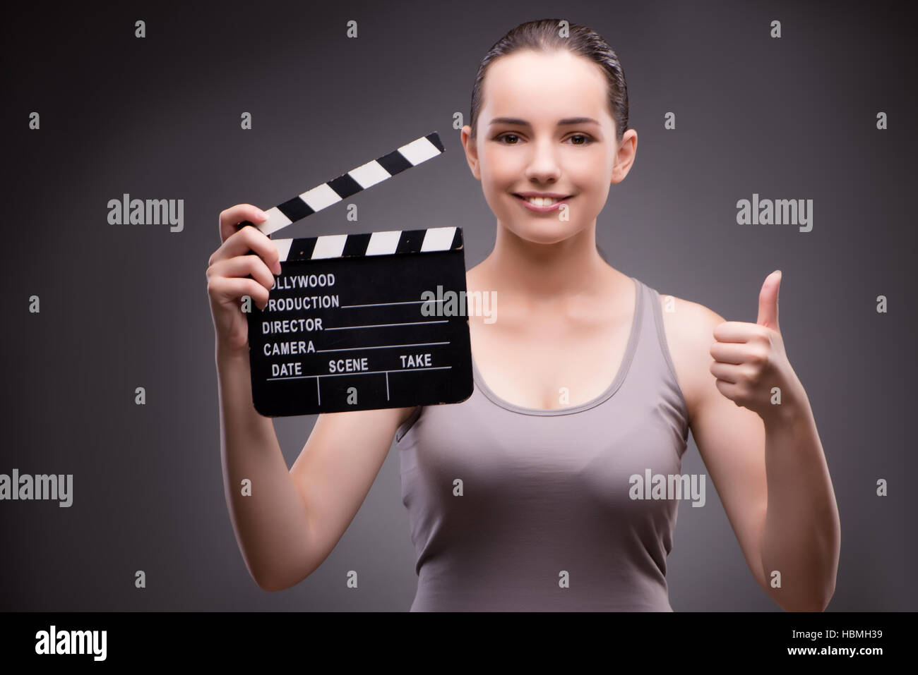 Woman with movie board in cinema concept Stock Photo - Alamy