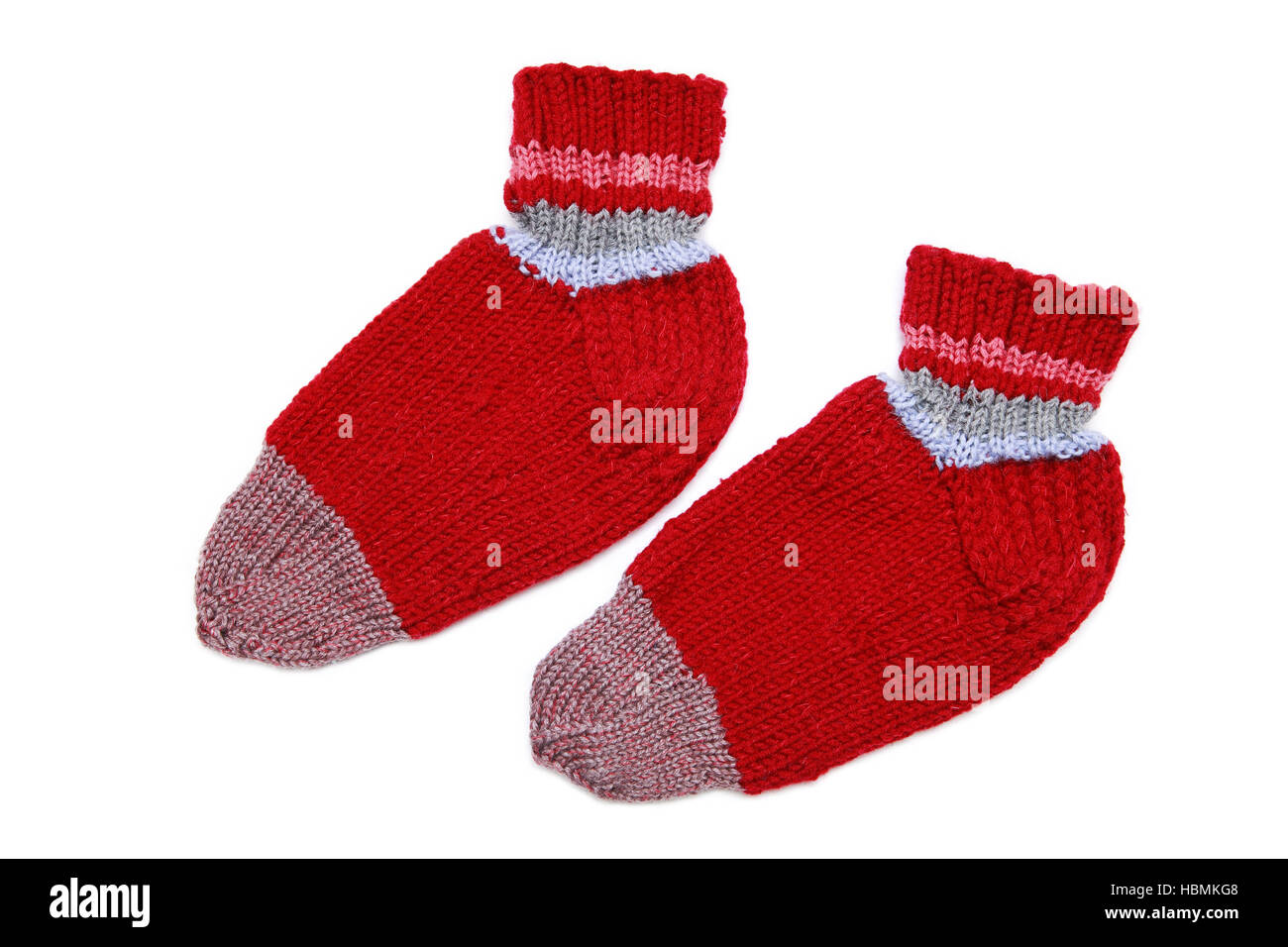 Knitted wool red socks on a white background Stock Photo - Alamy