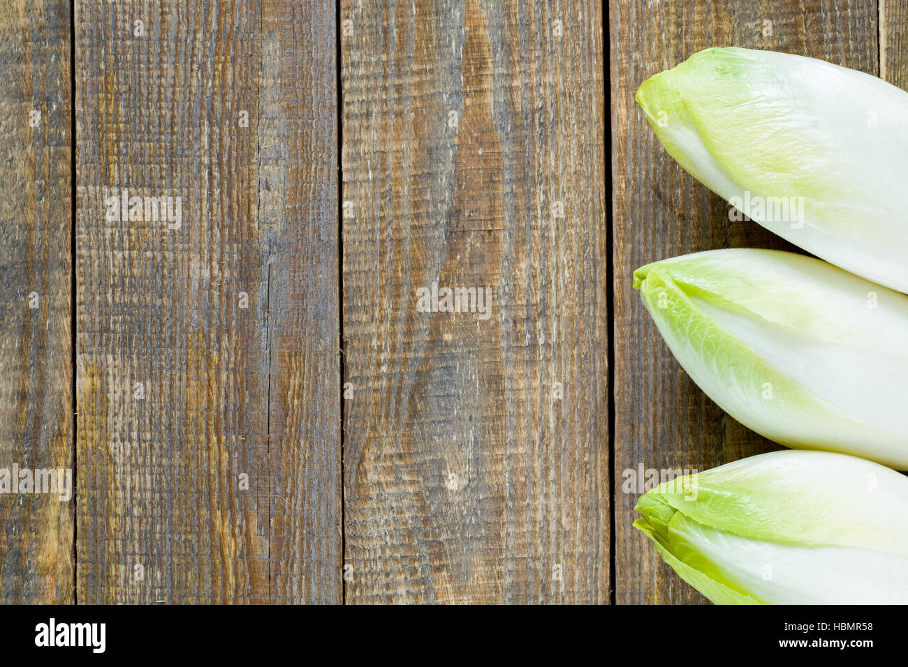 Belgian witloof on wooden table with copy space for yours words Stock ...