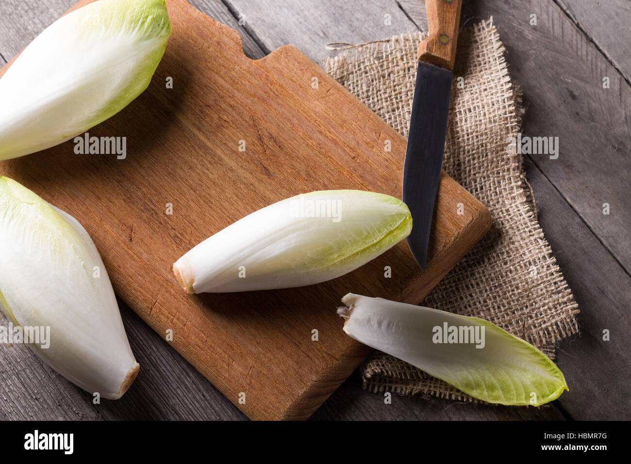 Top view on endive lying on wooden background Stock Photo - Alamy