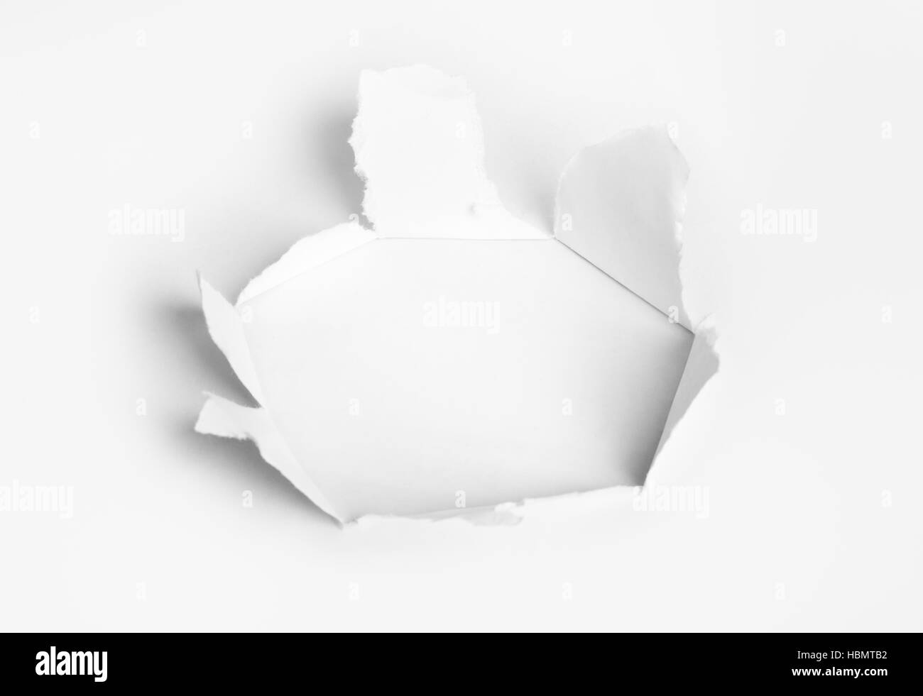 Hole punched in the paper Stock Photo - Alamy