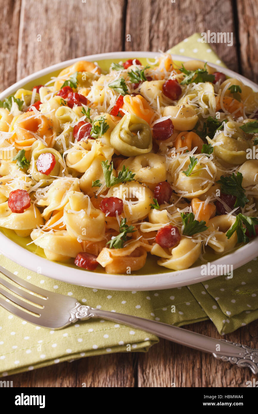 Traditional multi-colored tortellini with parmesan cheese and sausages ...