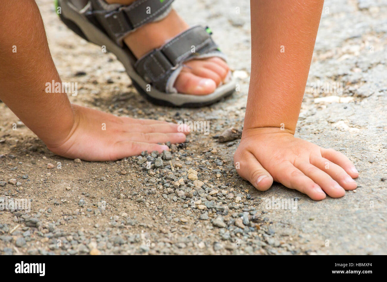 child playing with pebbles on the floor Stock Photo - Alamy
