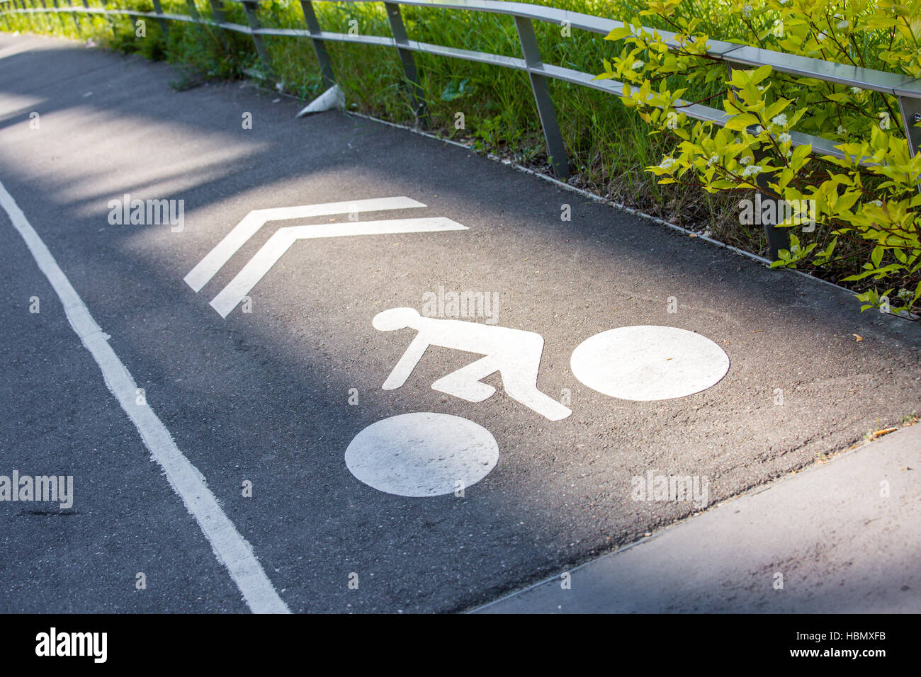 The cyclist road sign on the pavement Stock Photo - Alamy
