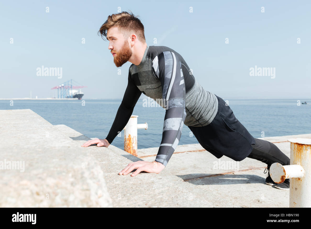 Young man pushed near the sea. side view Stock Photo - Alamy
