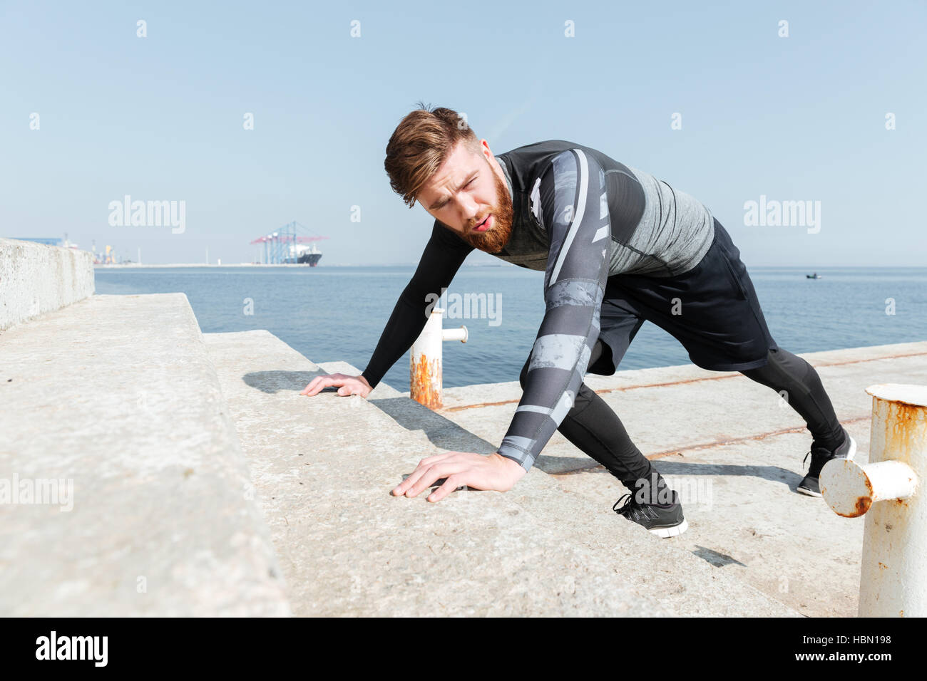 Handsome man pushed on stairs near the sea. looking away Stock Photo ...