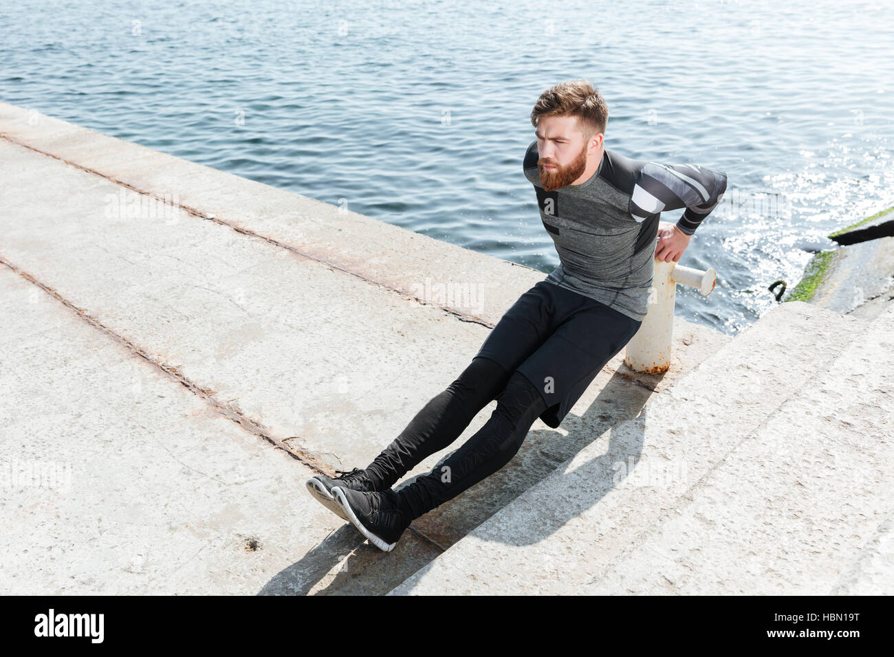 Fitness near the sea. man doing push ups. above view Stock Photo - Alamy