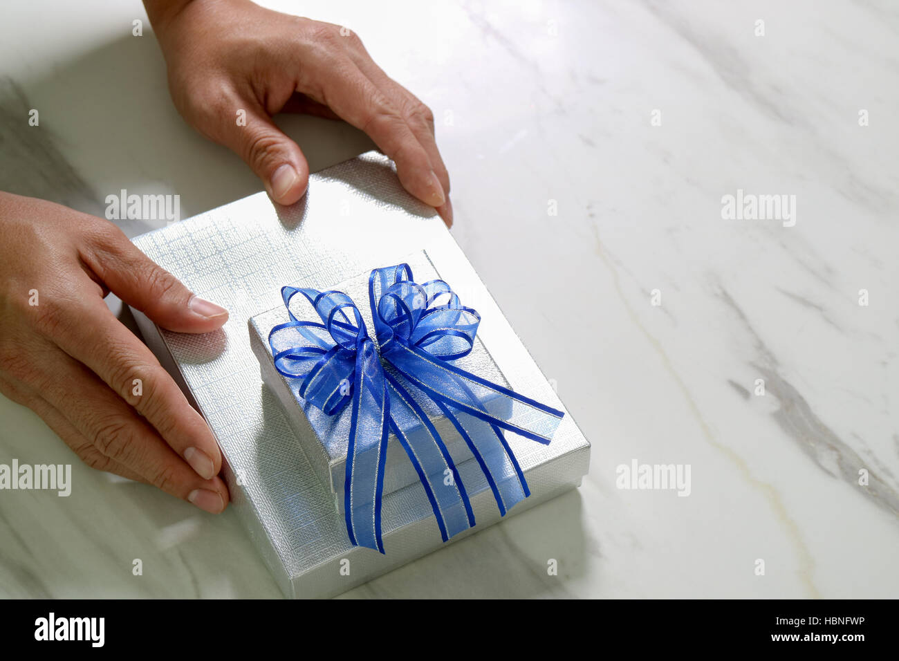 gift giving,man hand holding a gift box in a gesture of giving.blurred ...