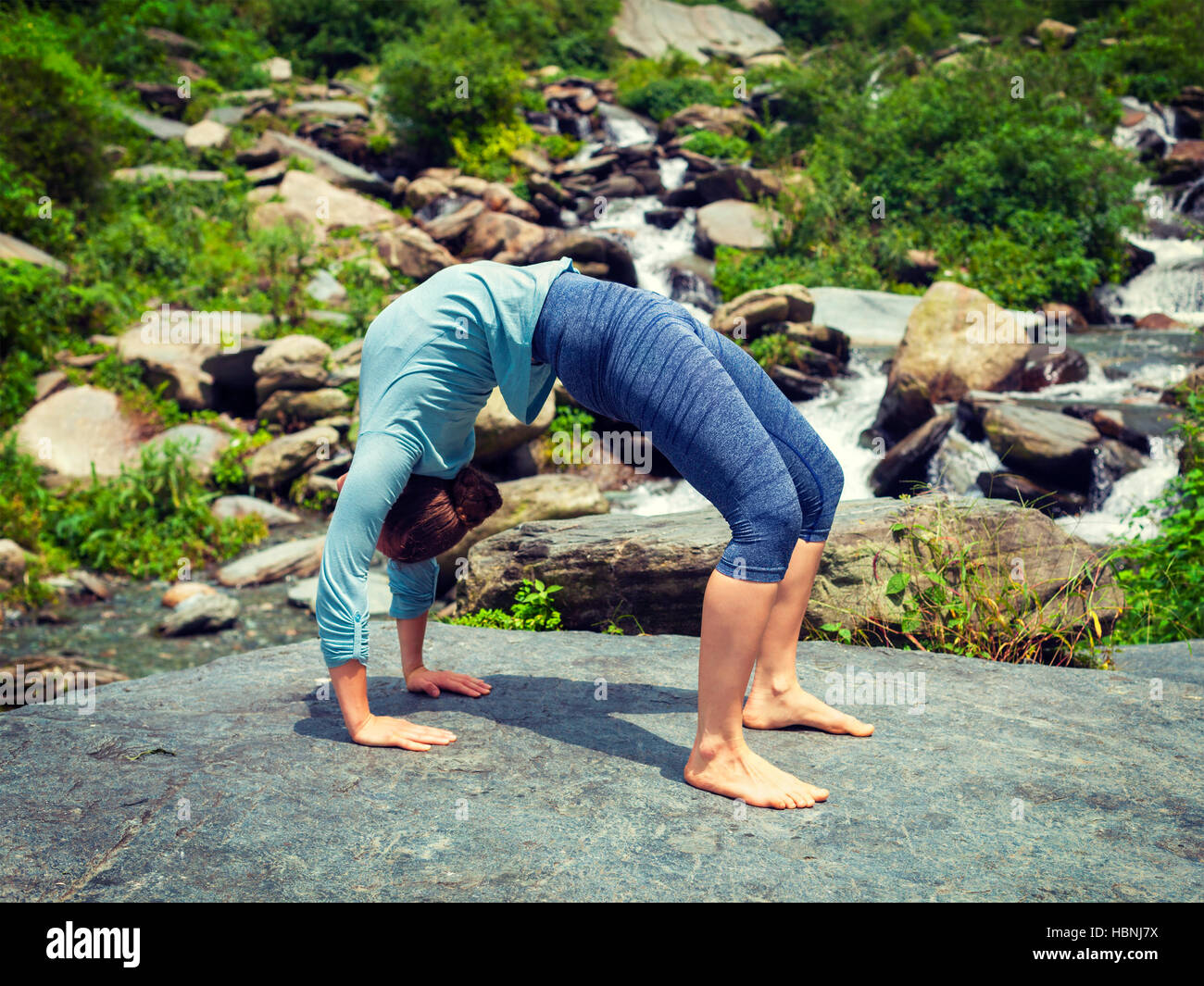 Woman doing Ashtanga Vinyasa Yoga asana Urdhva Dhanurasana - up Stock ...