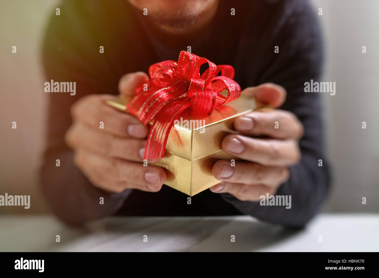 gift giving,man hand holding a gift box in a gesture of giving.blurred ...