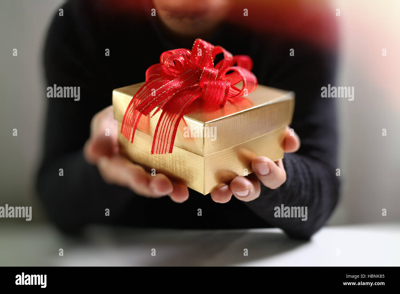 gift giving,man hand holding a gift box in a gesture of giving.blurred ...