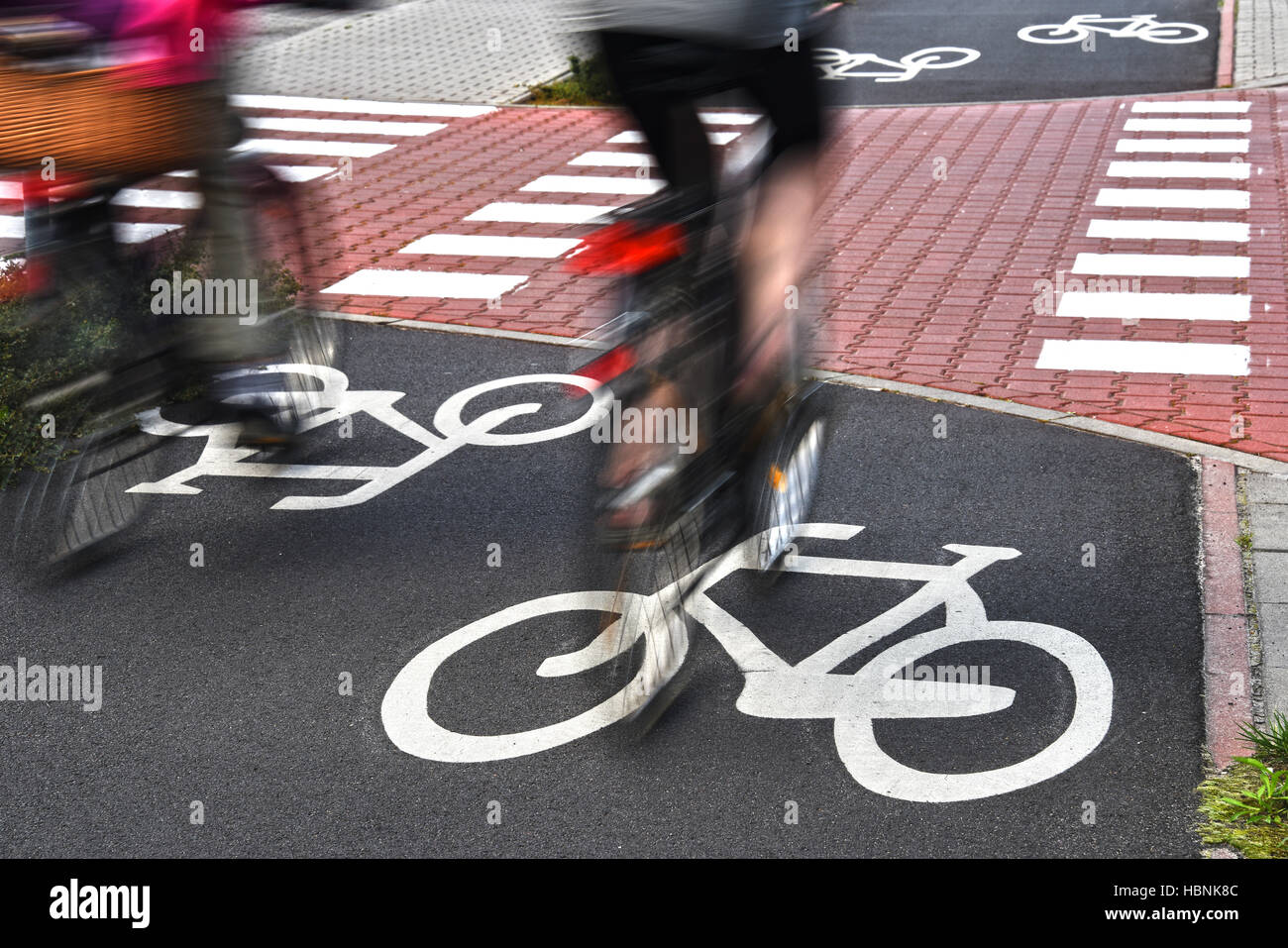 Bicycle road sign and bike riders Stock Photo - Alamy
