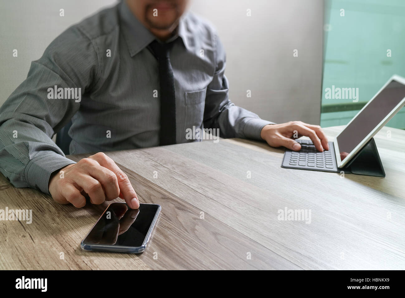 businessman using smart phone and keyboard dock digital tablet.Worldwide network connection ...