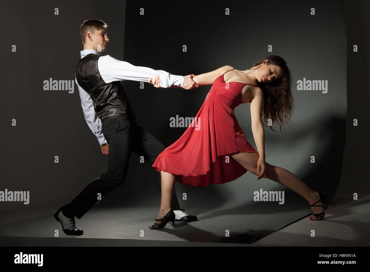 Dancing couple holding hands Stock Photo - Alamy