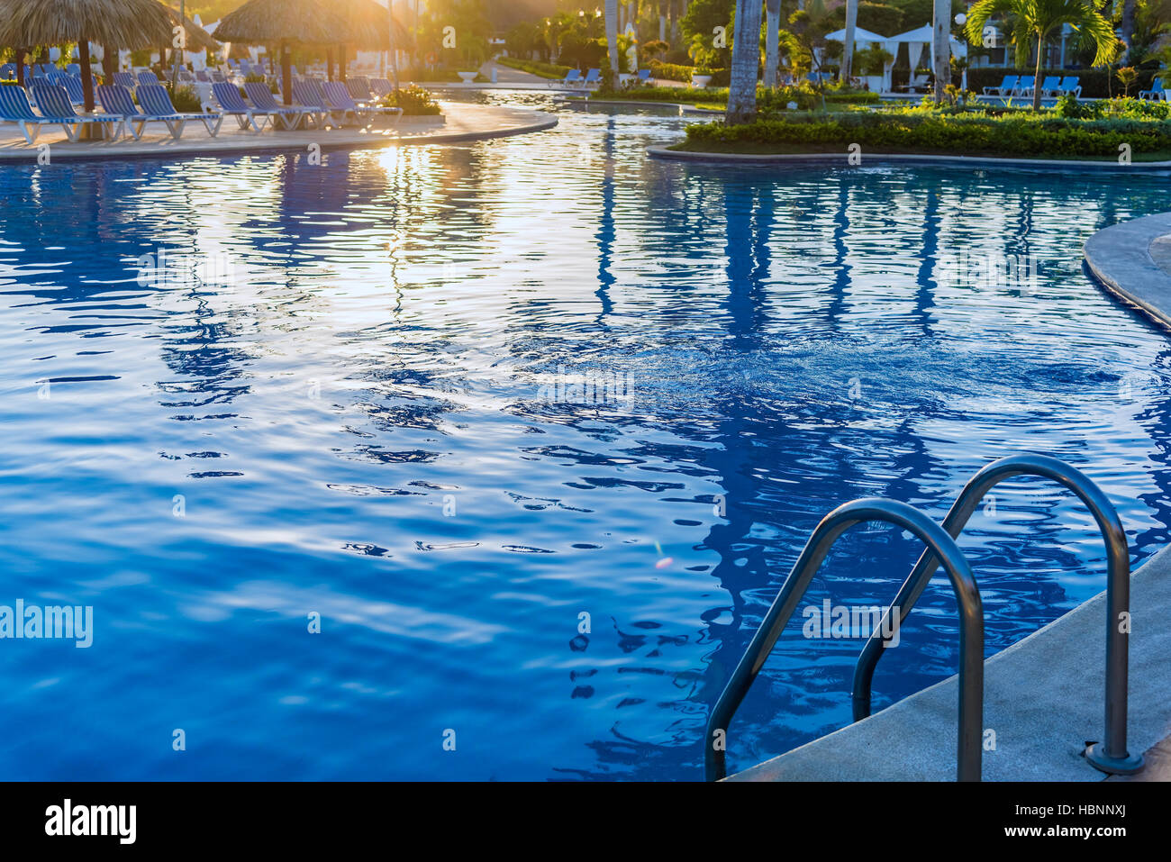 a swimming pool with sun loungers Stock Photo - Alamy