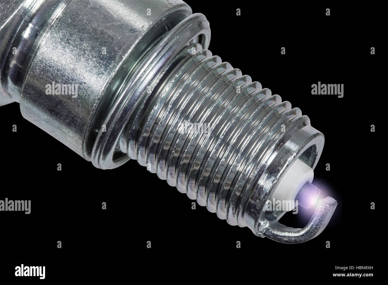Spark plug, isolated on black background Stock Photo - Alamy