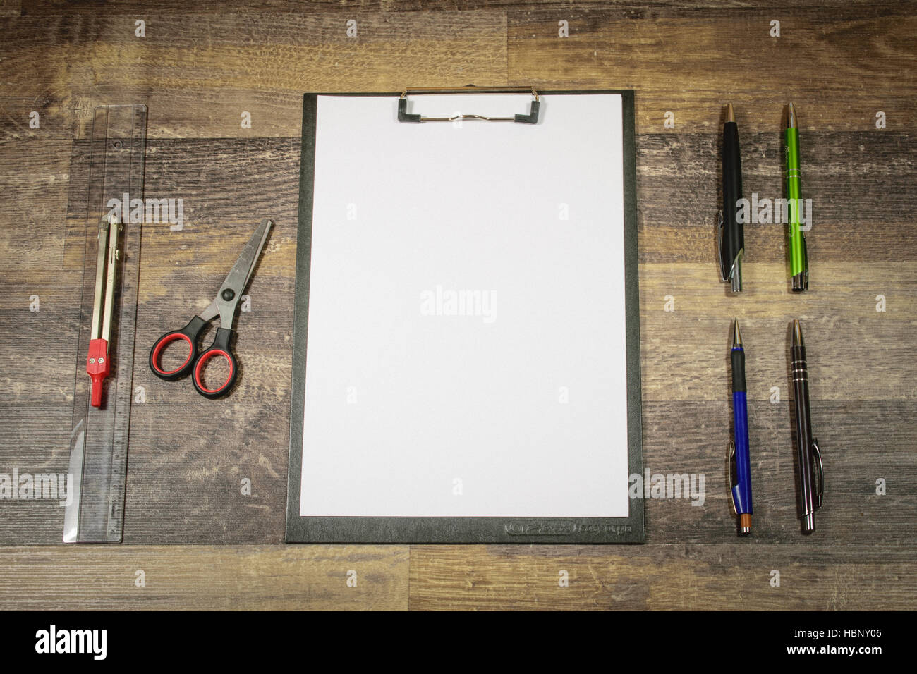 Flat Lay - On a subsoil of wood are clear arranged a clamp board with a ...