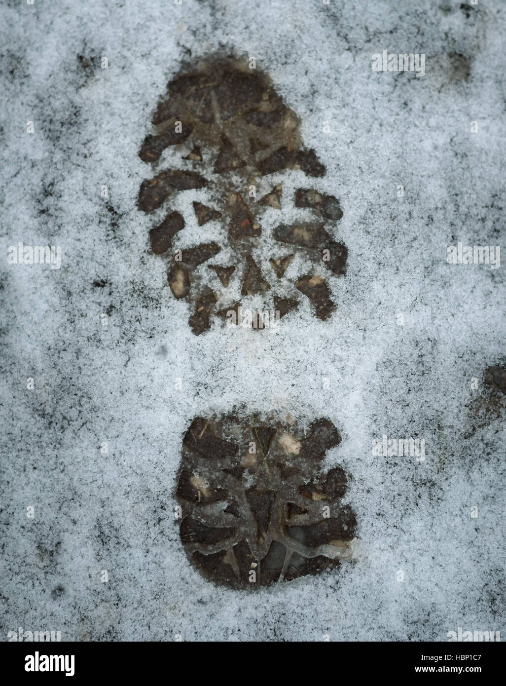 Footprint background after boot on the white snow Stock Photo - Alamy