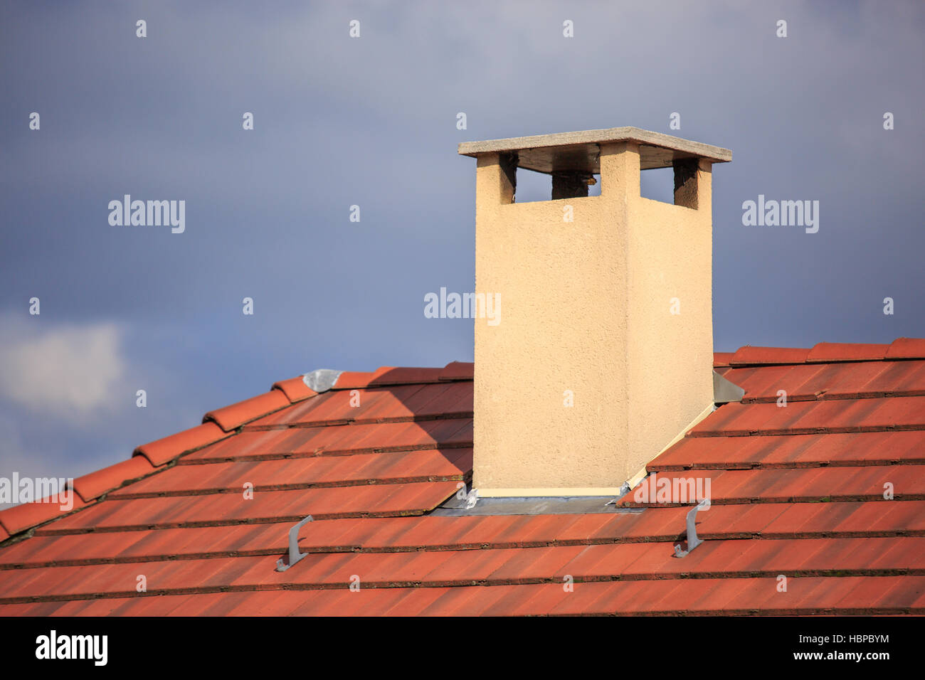 The chimney on top of a red roof Stock Photo - Alamy
