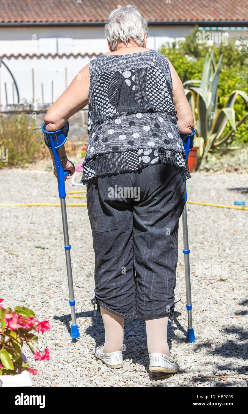 Old woman crutches hi-res stock photography and images - Alamy