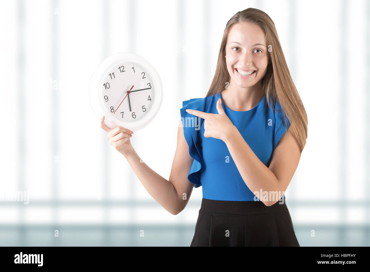 Woman Pointing at Clock Stock Photo - Alamy