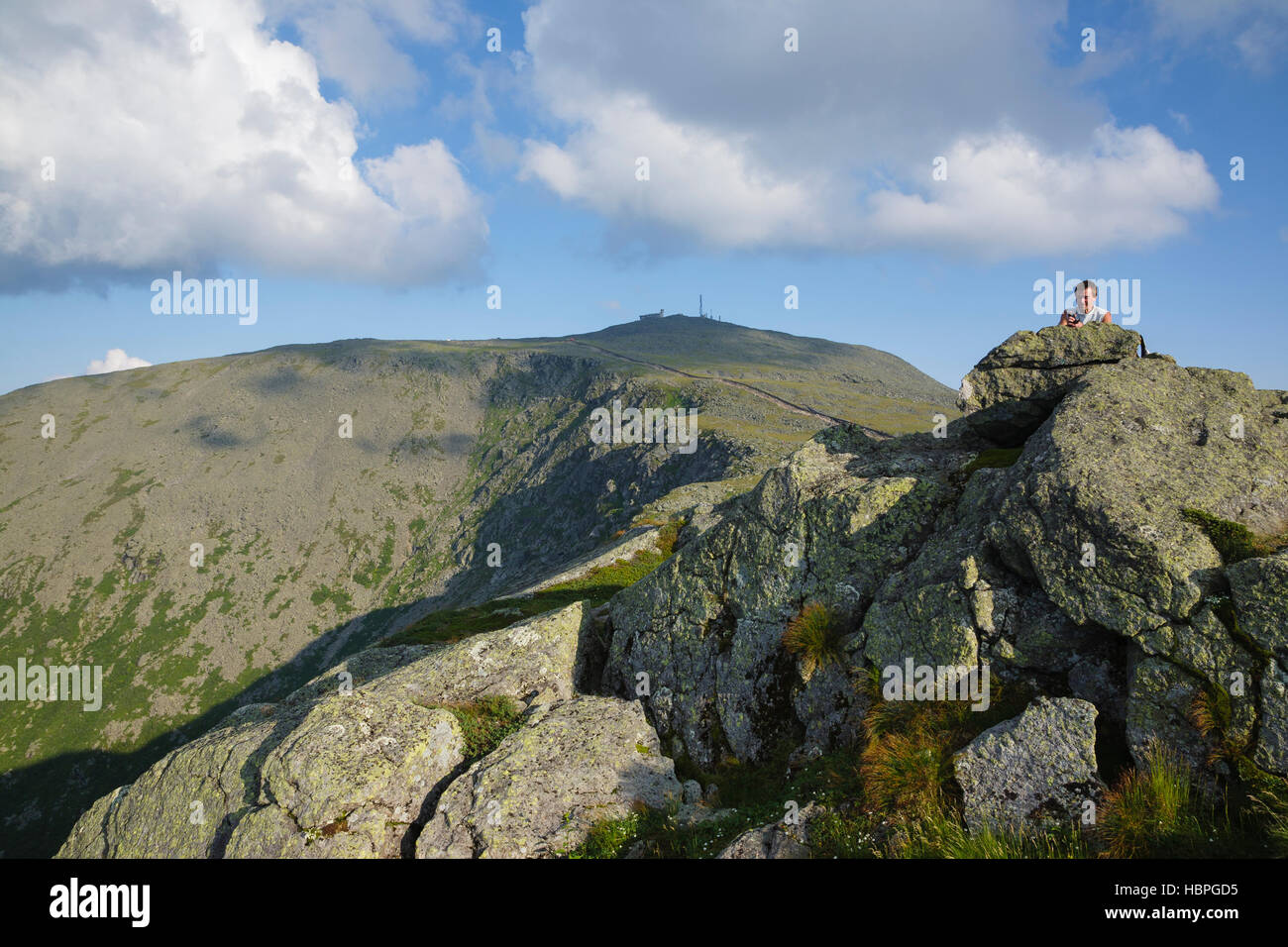 A hiker takes in the view of Mount Washington from Mount Clay in ...
