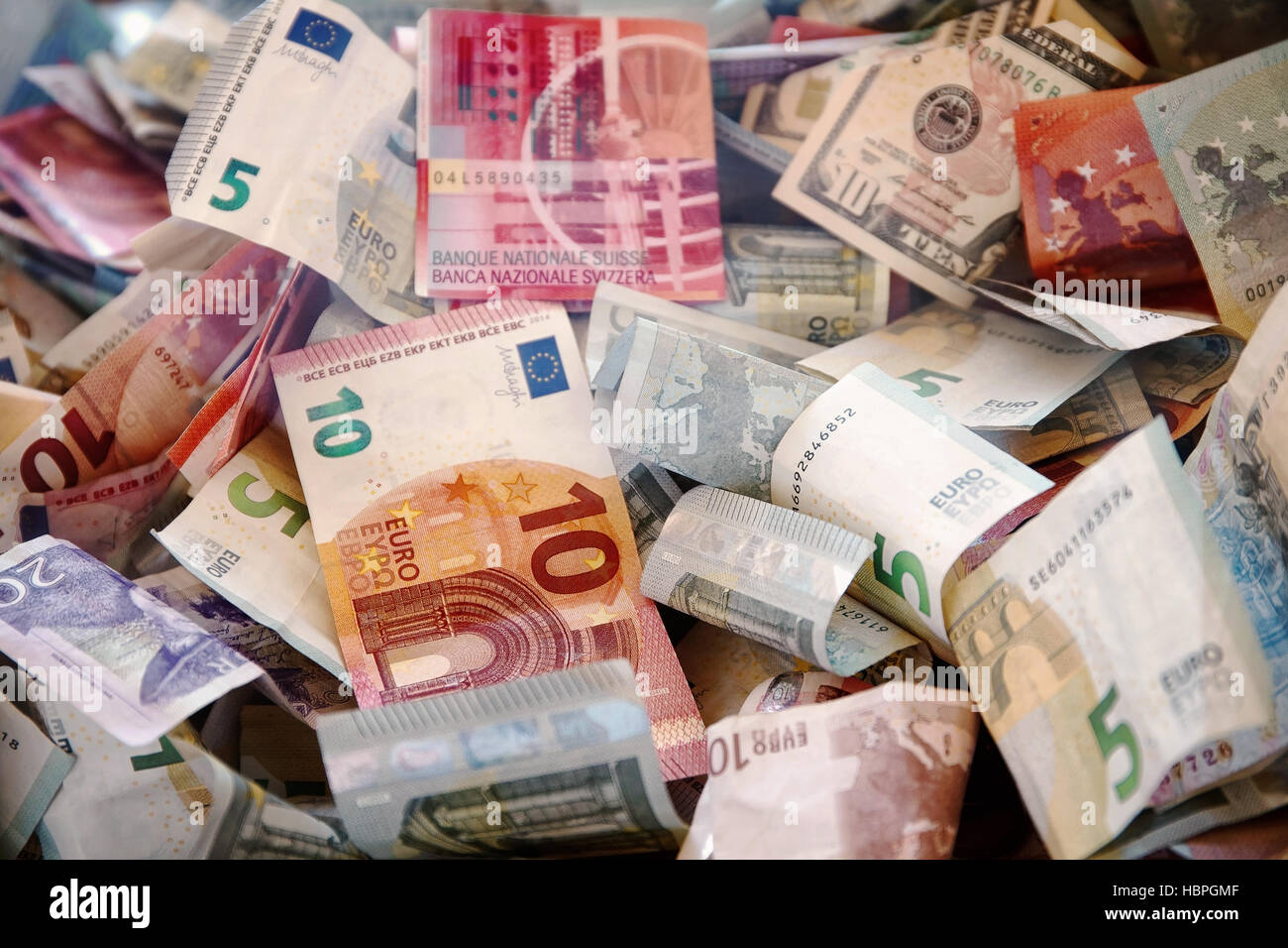 Banknotes of different countries and wrinkled overlapping randomly ...