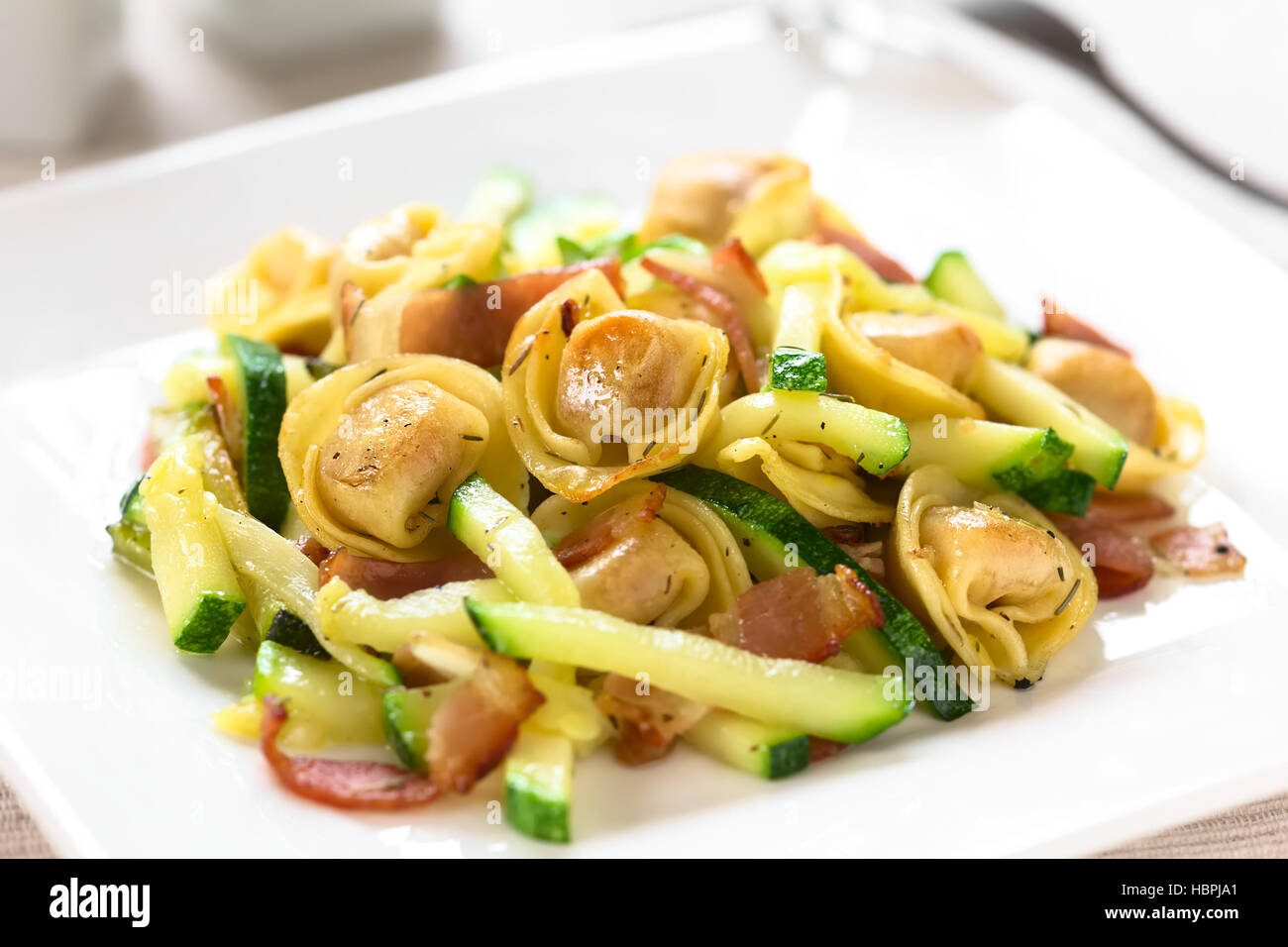 Baked cheese tortellini or belly button pasta with zucchini, bacon and ...