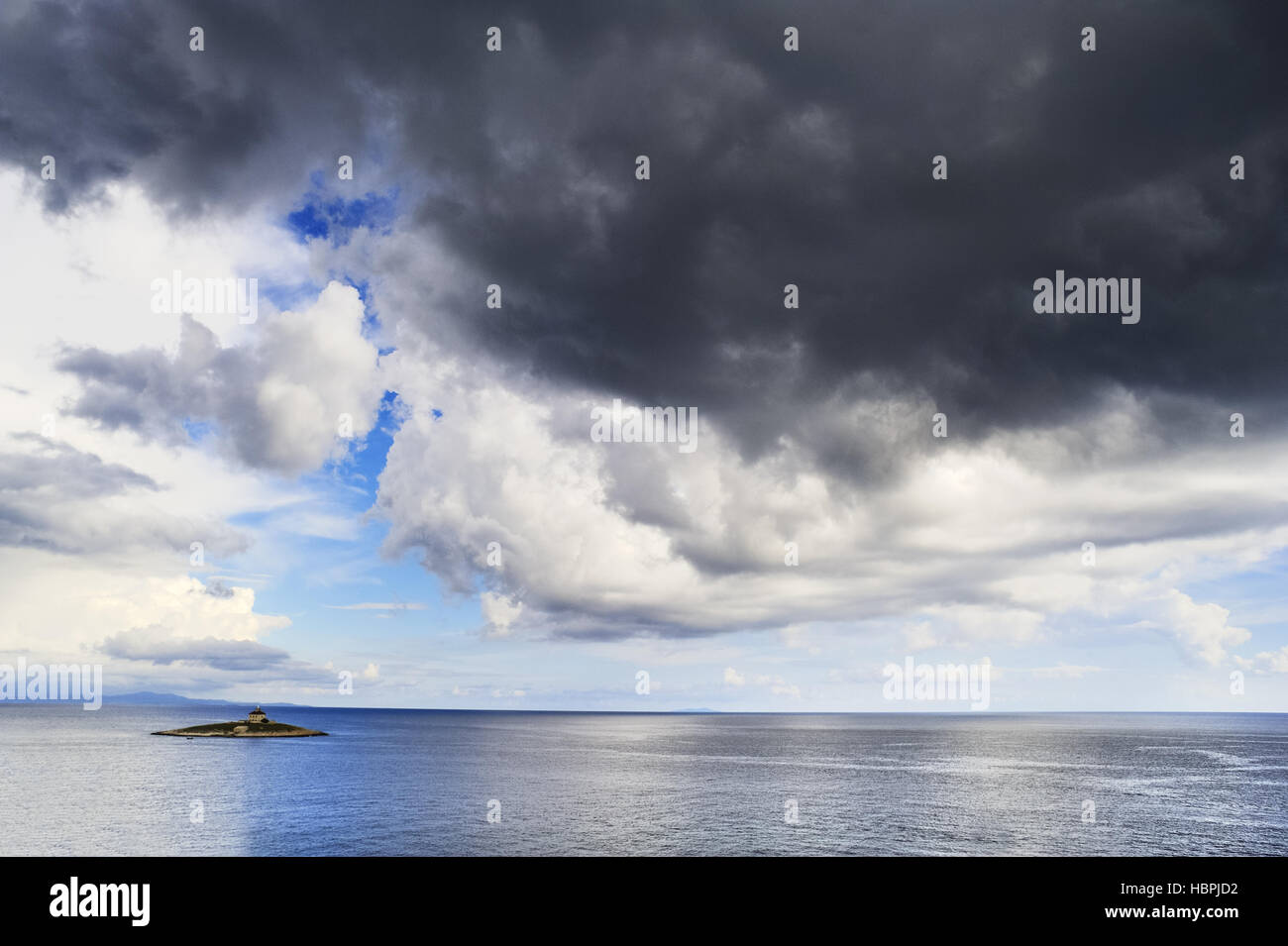 Island with lighthouse in the sea Stock Photo - Alamy