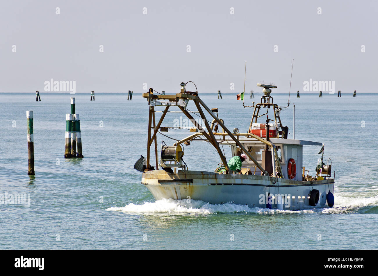 fishing boat driving at a navigation channel Stock Photo - Alamy
