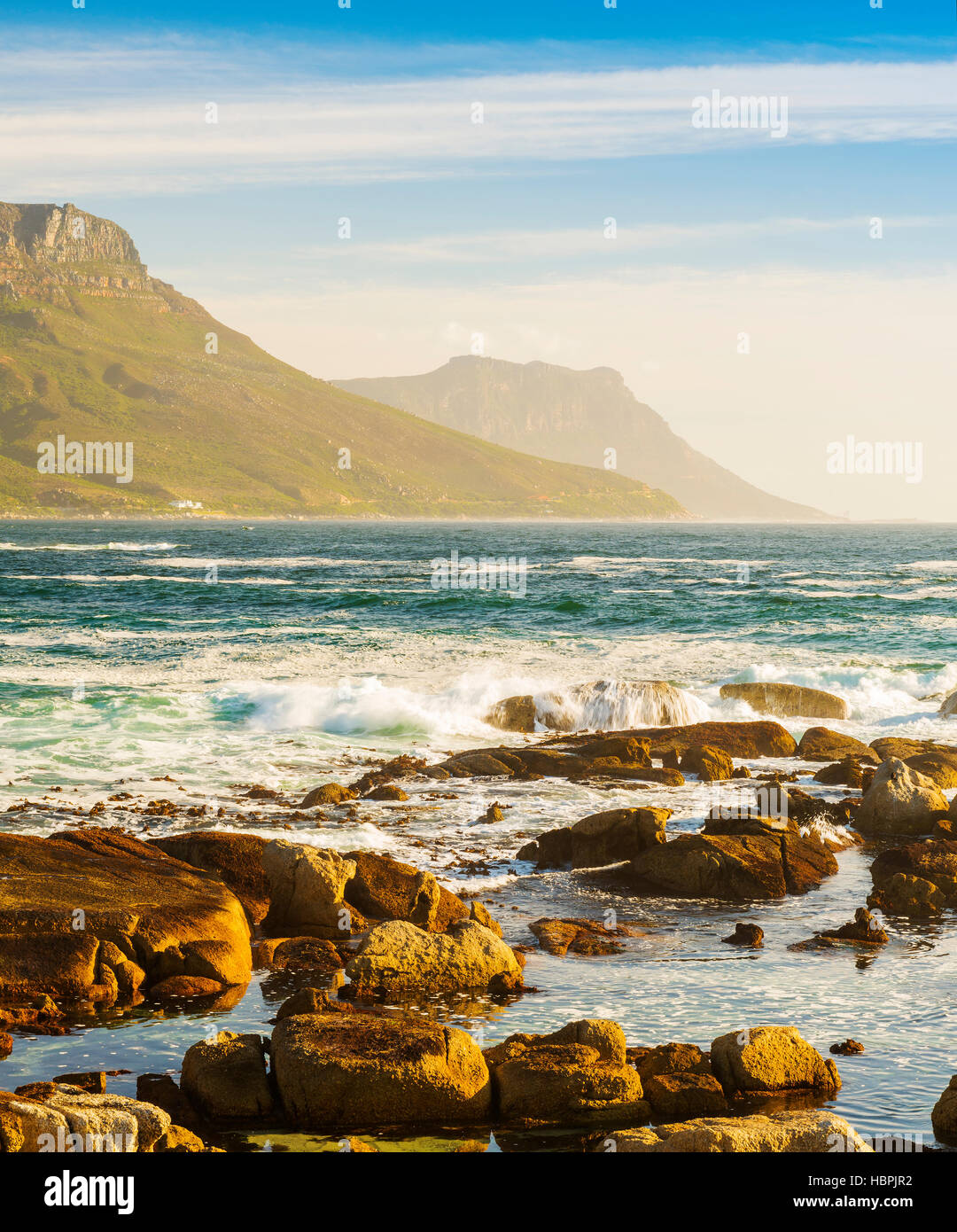 Coastal rocks and mountains with ocean horizon Stock Photo - Alamy