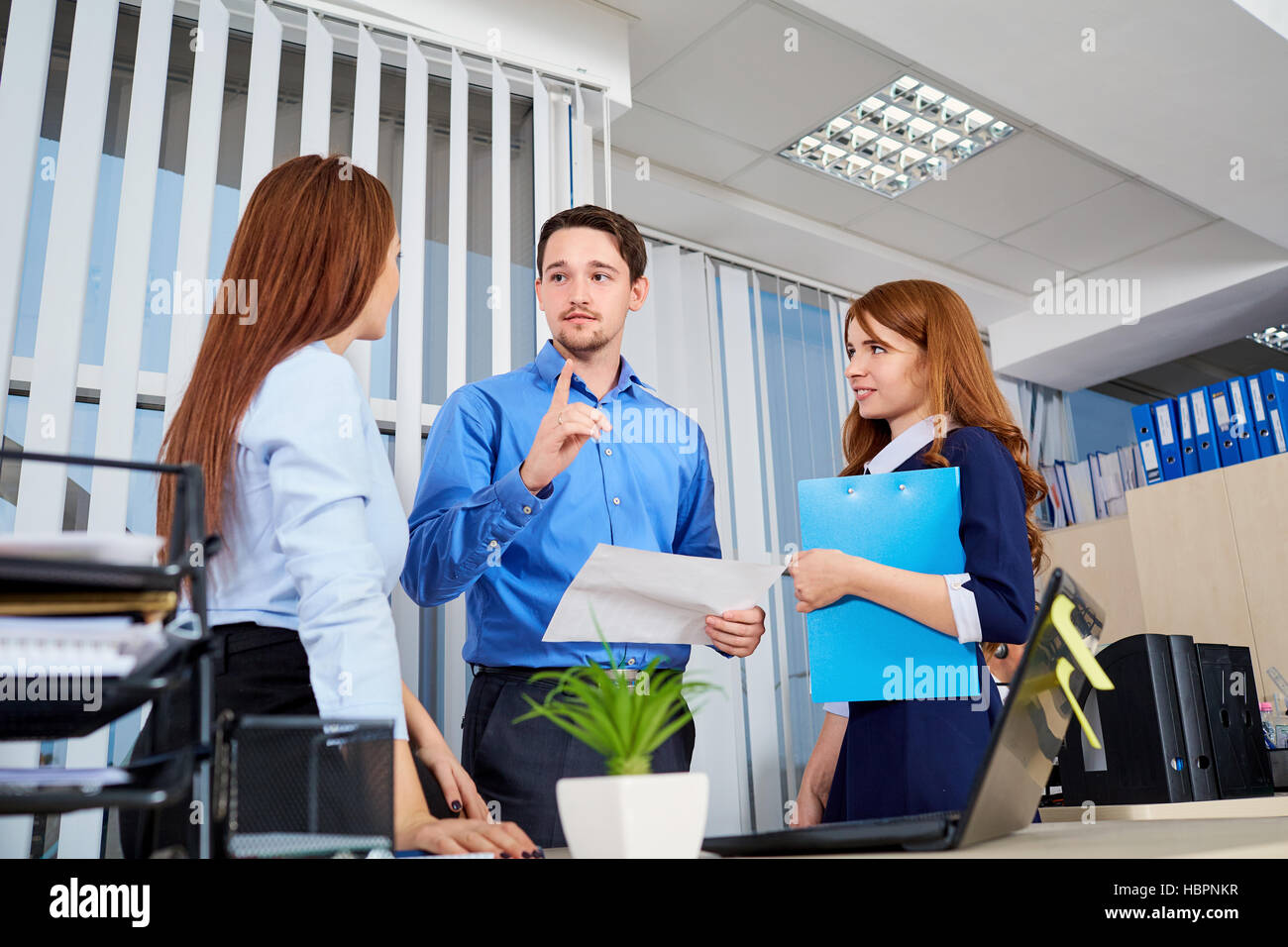 Business team in an office communicating with documents their Stock ...