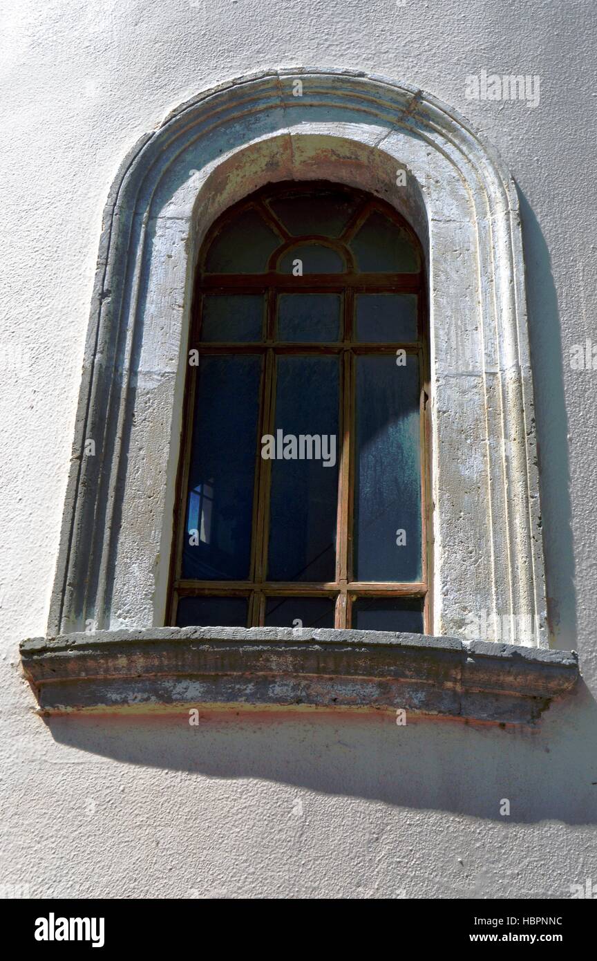 A window on a tower with an arch Stock Photo - Alamy