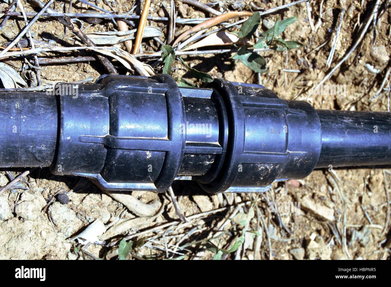 Join plastic water pipe with a muff Stock Photo - Alamy