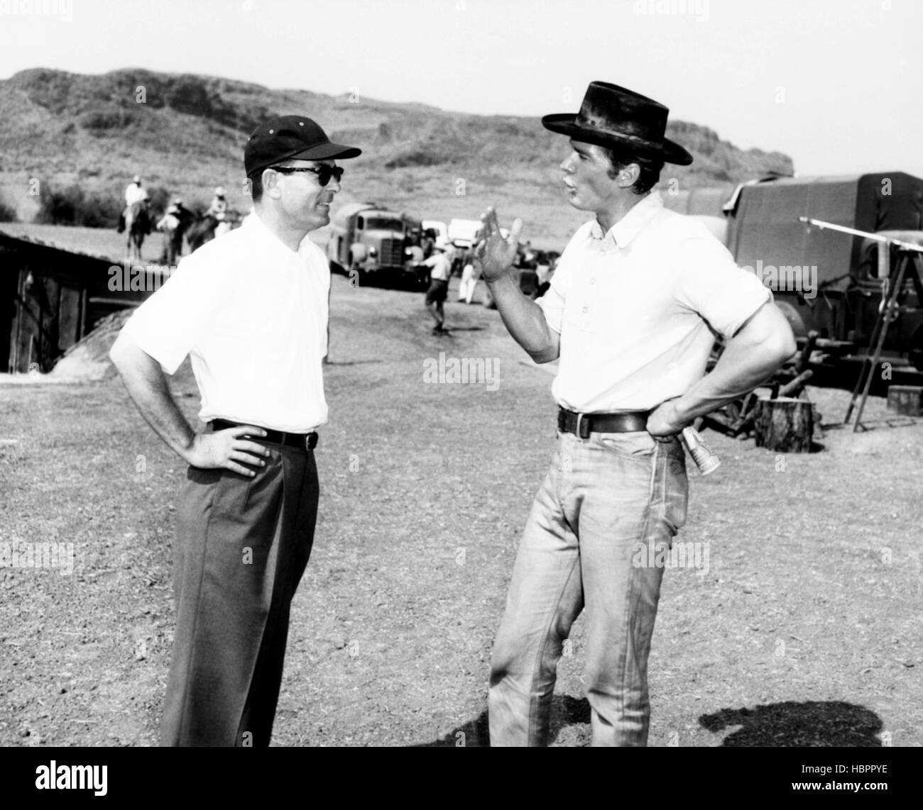 FLAMING STAR, from left, producer David Weisbart, Steve Forrest, on-set ...