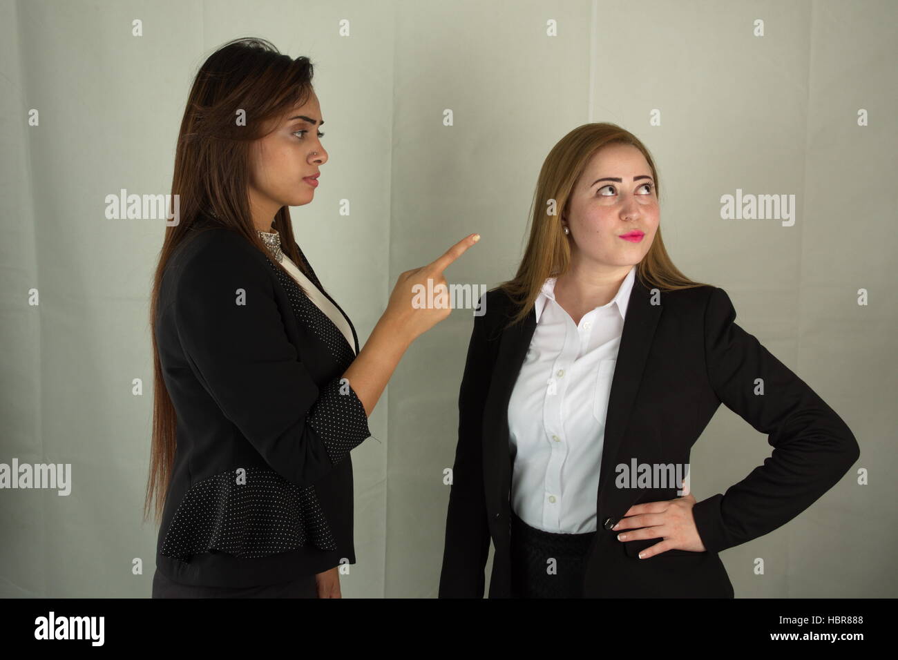 Two Egyptian business woman reprehension: one woman waves her finger at ...