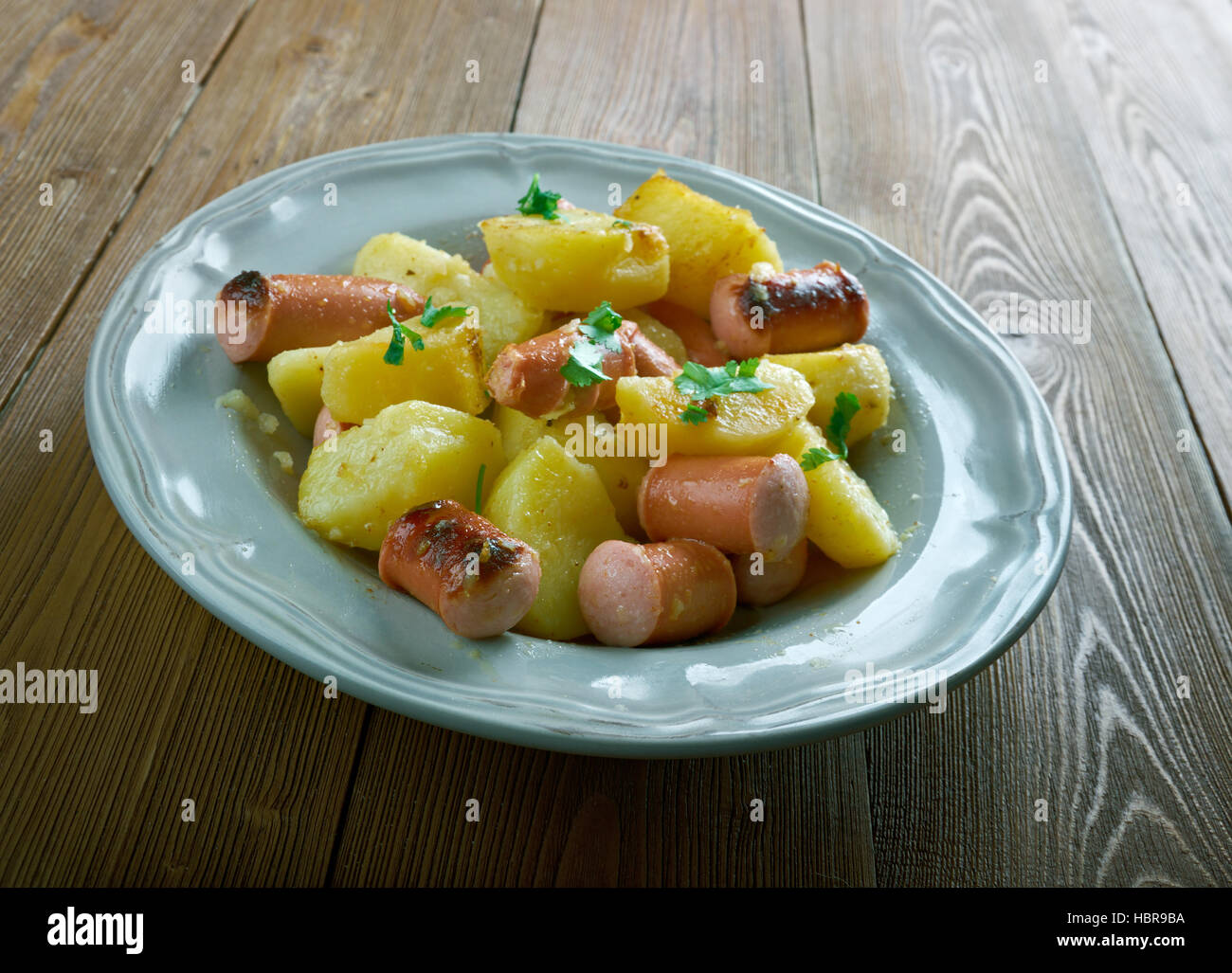 Finnish Fried potatoes with sausages Stock Photo - Alamy