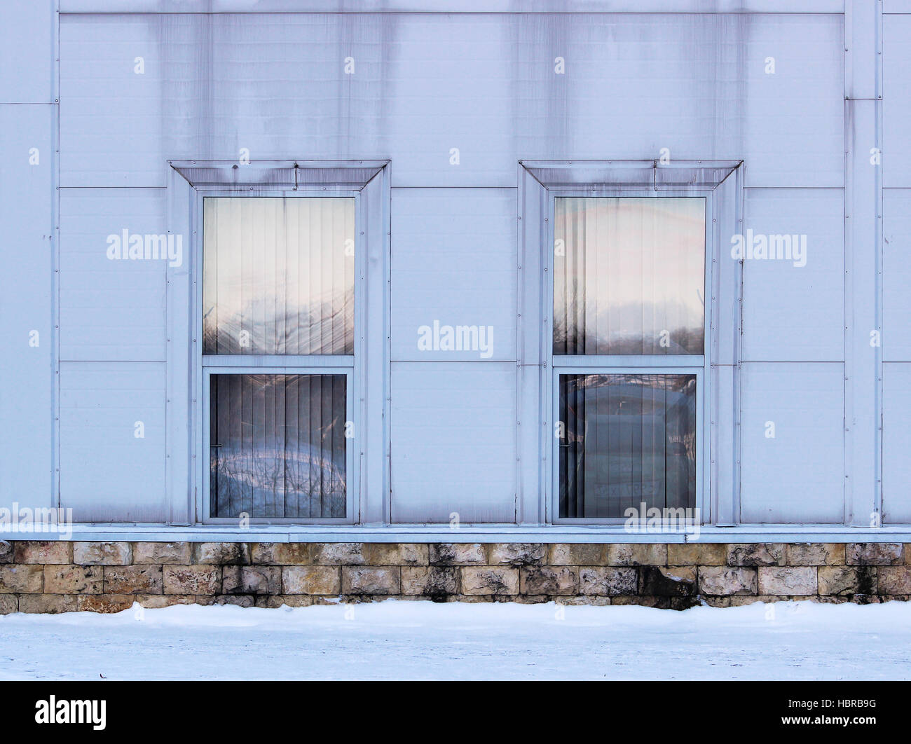 two rectangular windows with siding imitating steel, on large sports ...