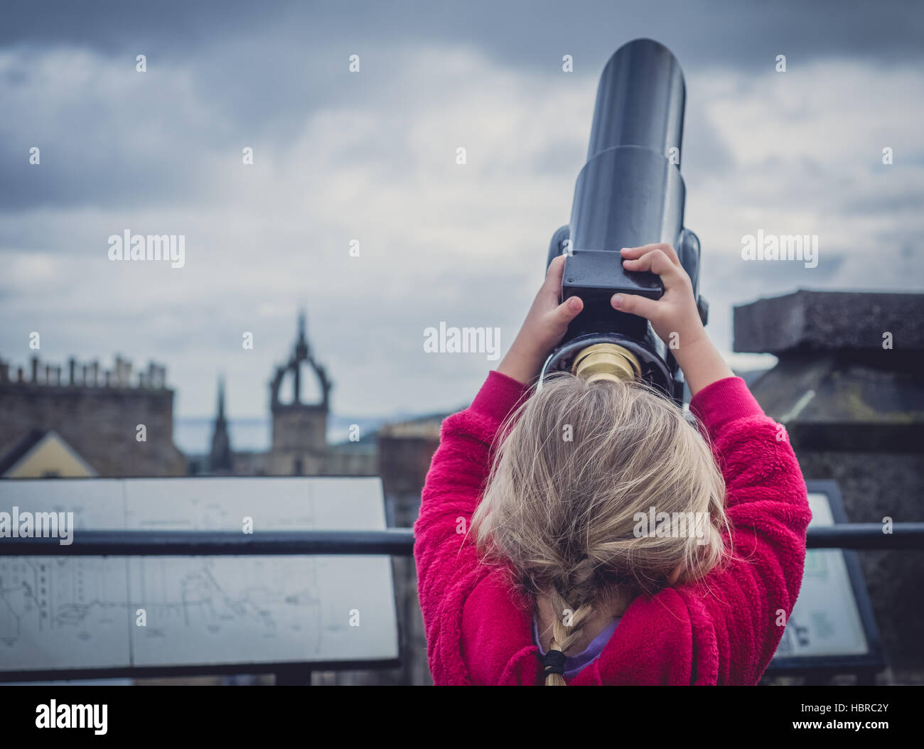 Little girl looking through the telescope Stock Photo - Alamy