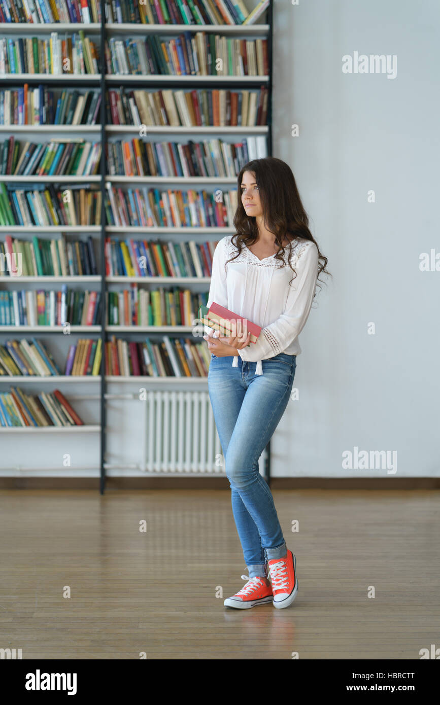 Student in a library Stock Photo - Alamy