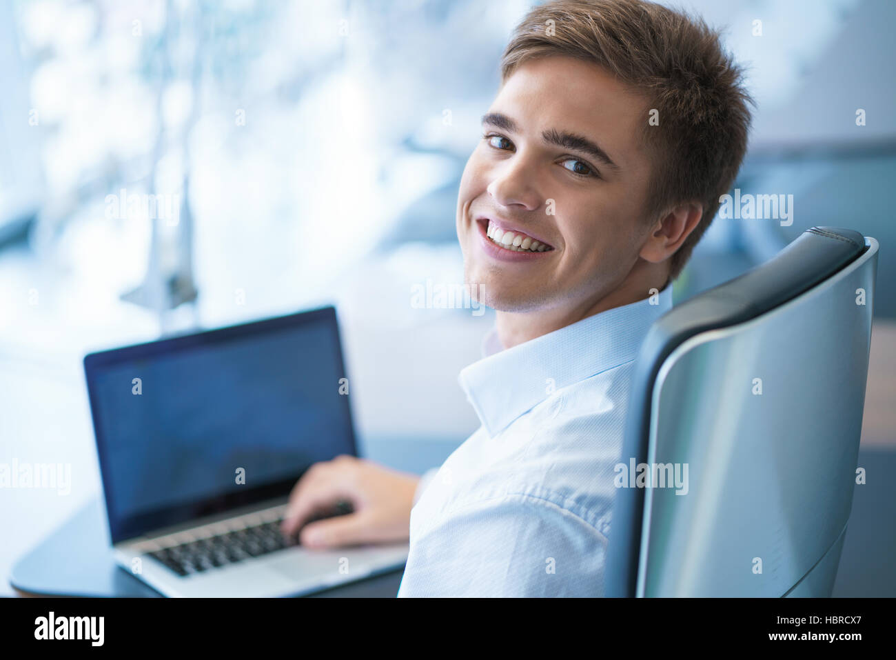 Happy man with laptop Stock Photo - Alamy